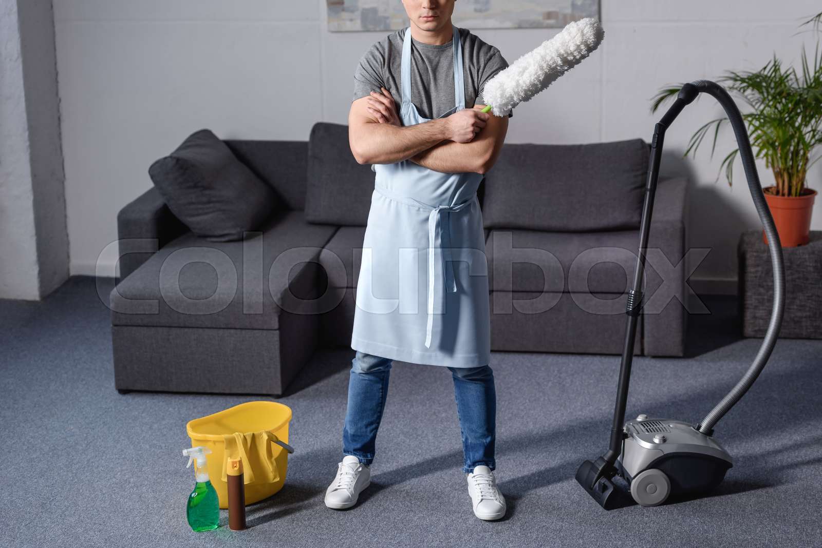cropped image of man standing and holding brush for cleaning dust in ...