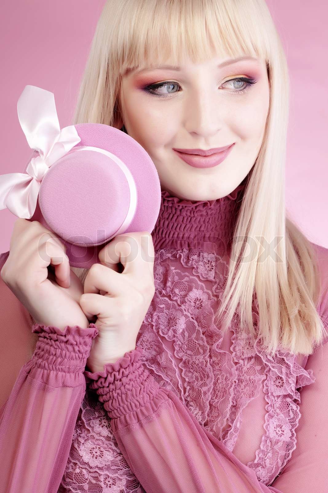 Portrait of pretty doll-like girl over pink | Stock image | Colourbox