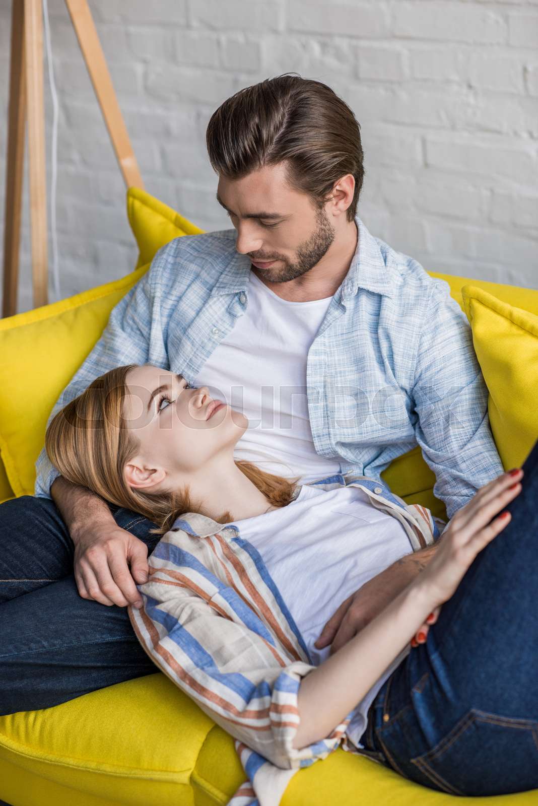 stylish young woman laying on boyfriend knees | Stock image | Colourbox