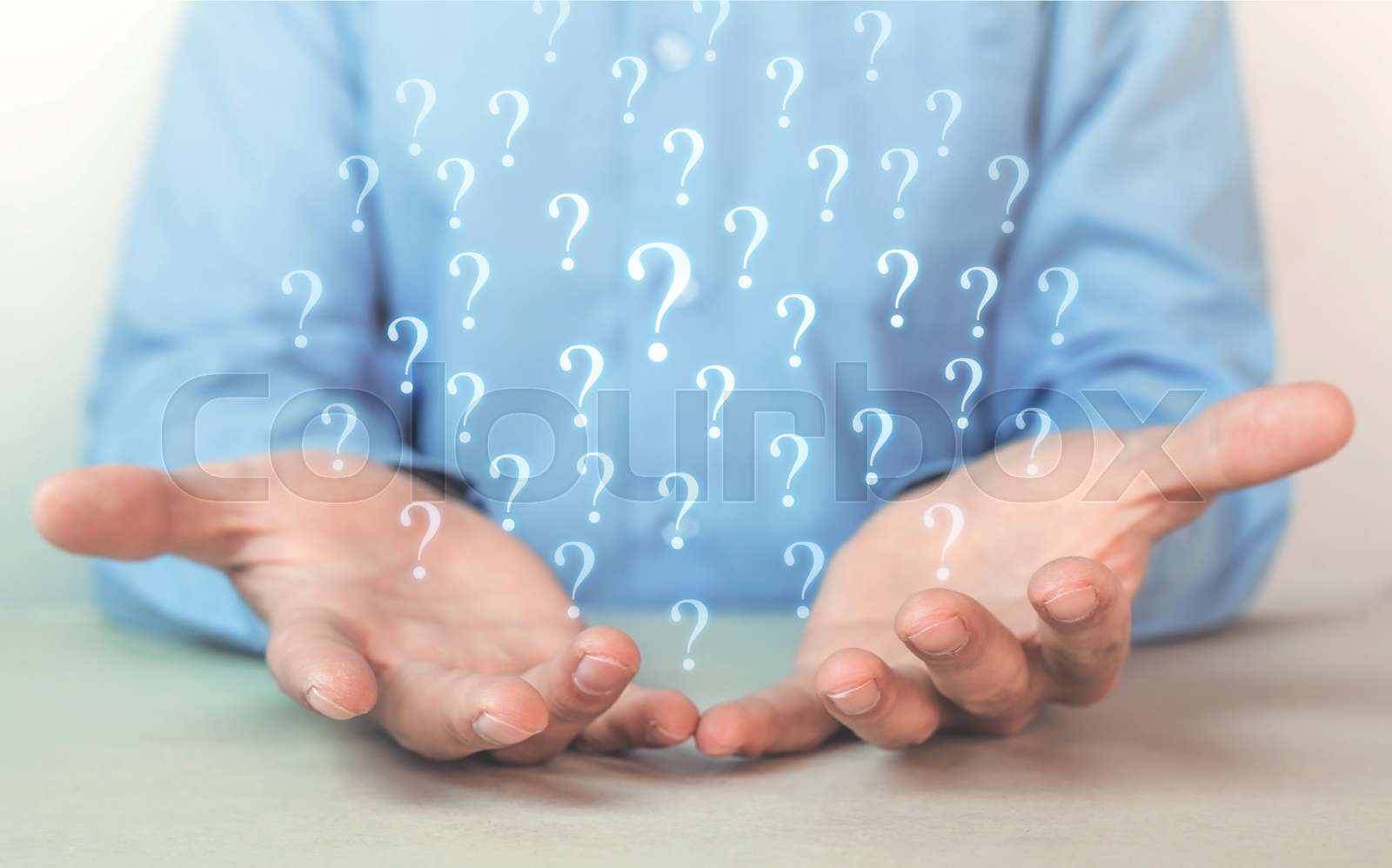Man holding question marks. Business concept | Stock image | Colourbox