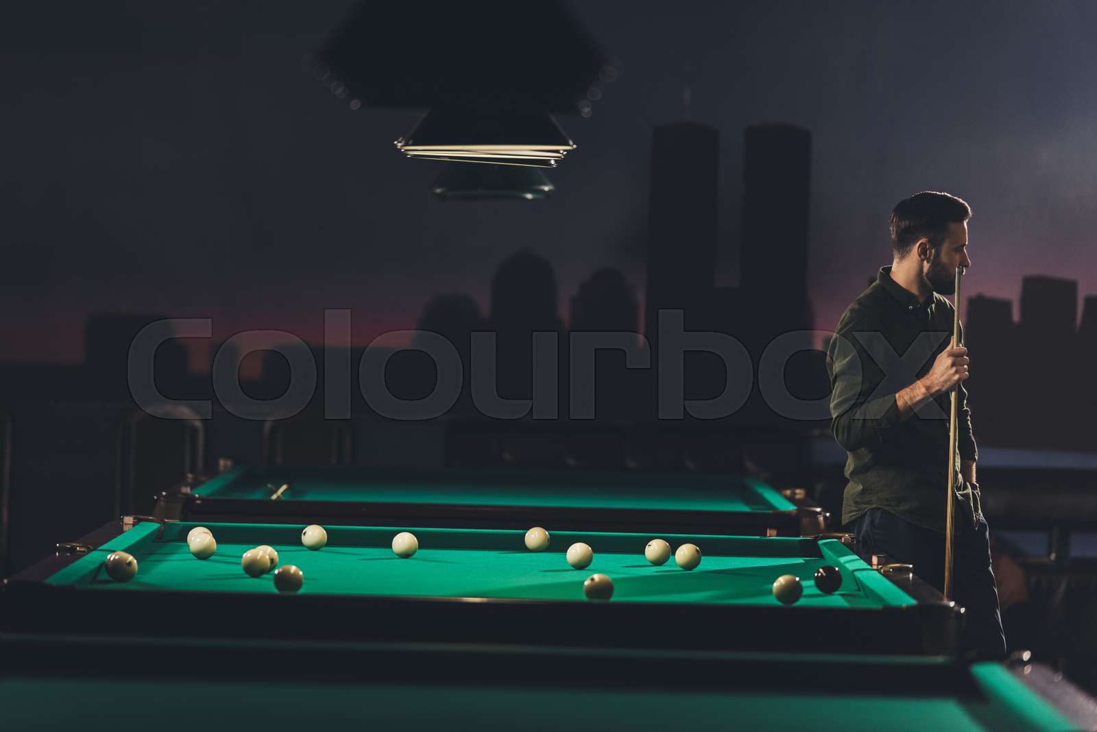 successful handsome man standing beside pool table at bar | Stock image ...