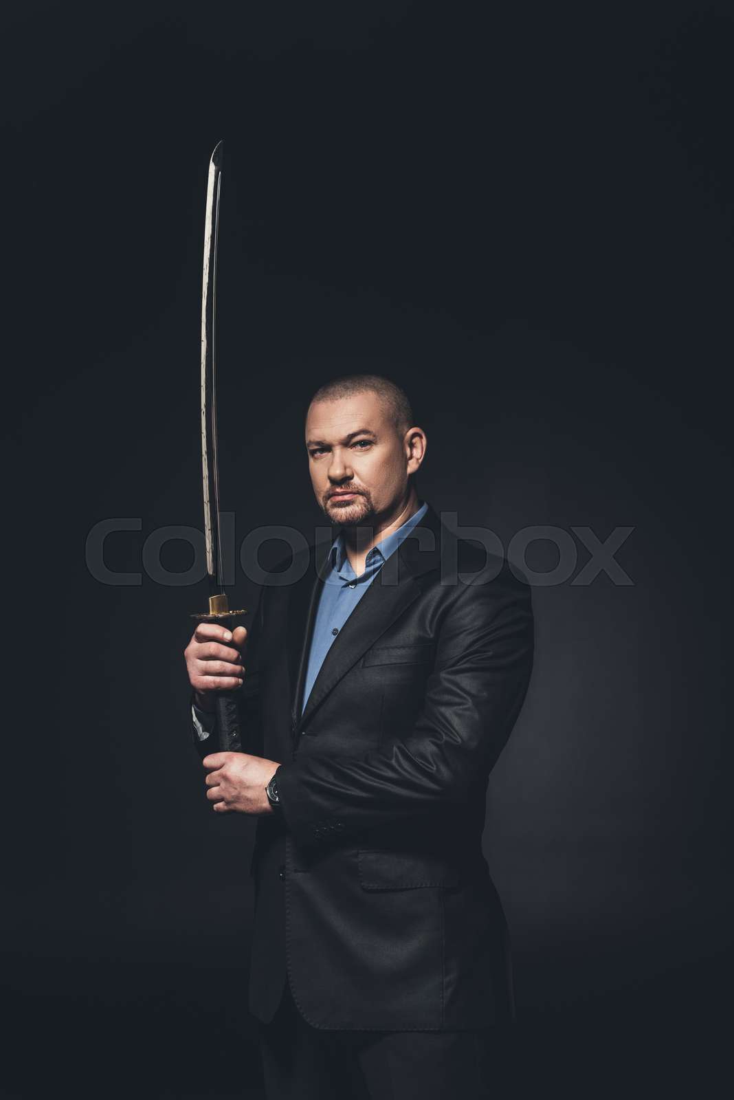 modern samurai in formal suit with katana sword looking at camera on ...