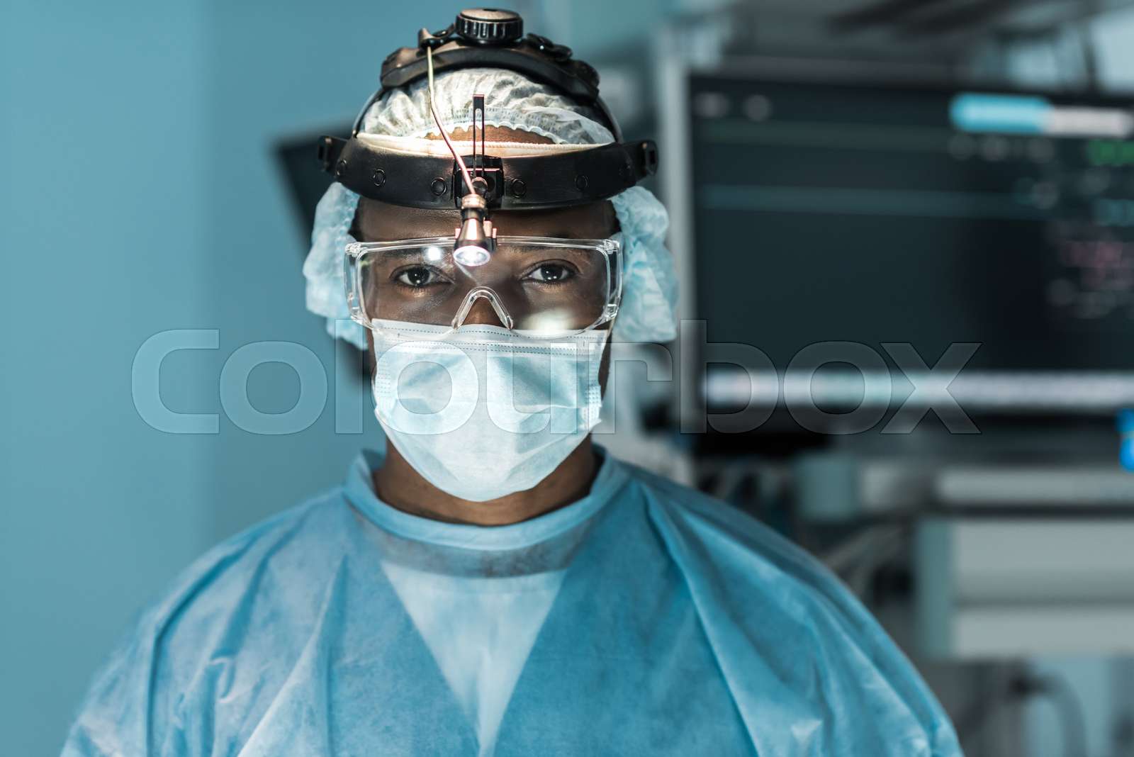 african american surgeon looking at camera in operating room | Stock ...