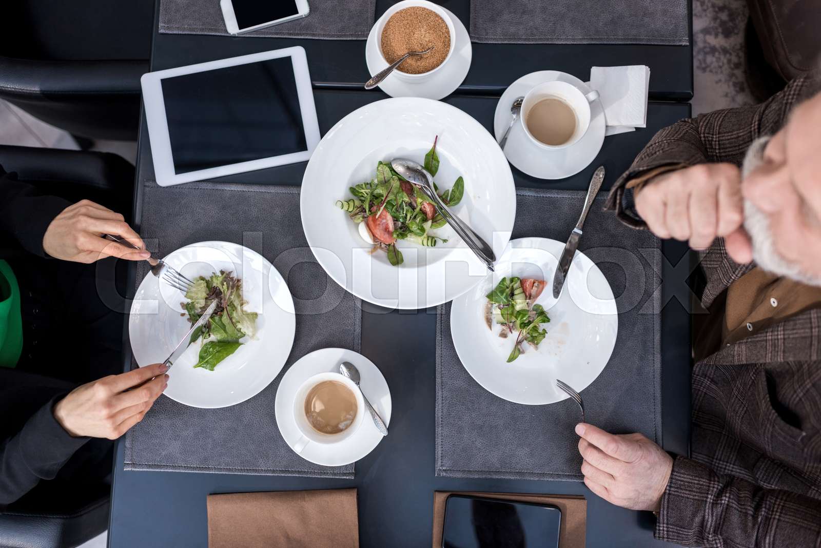 overhead view of man and woman having dinner together in restaurant ...
