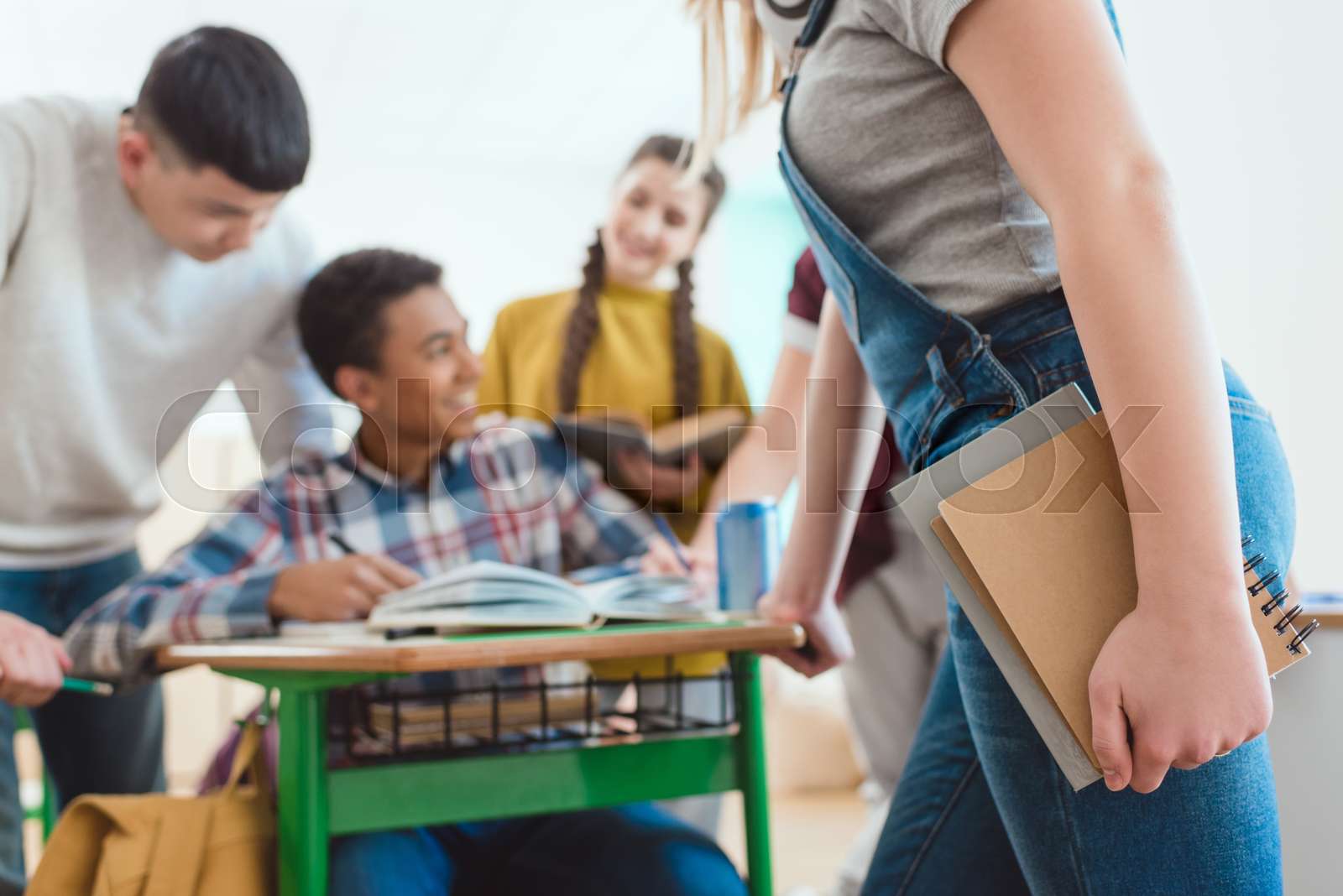high school students helping their classmate with homework | Stock ...