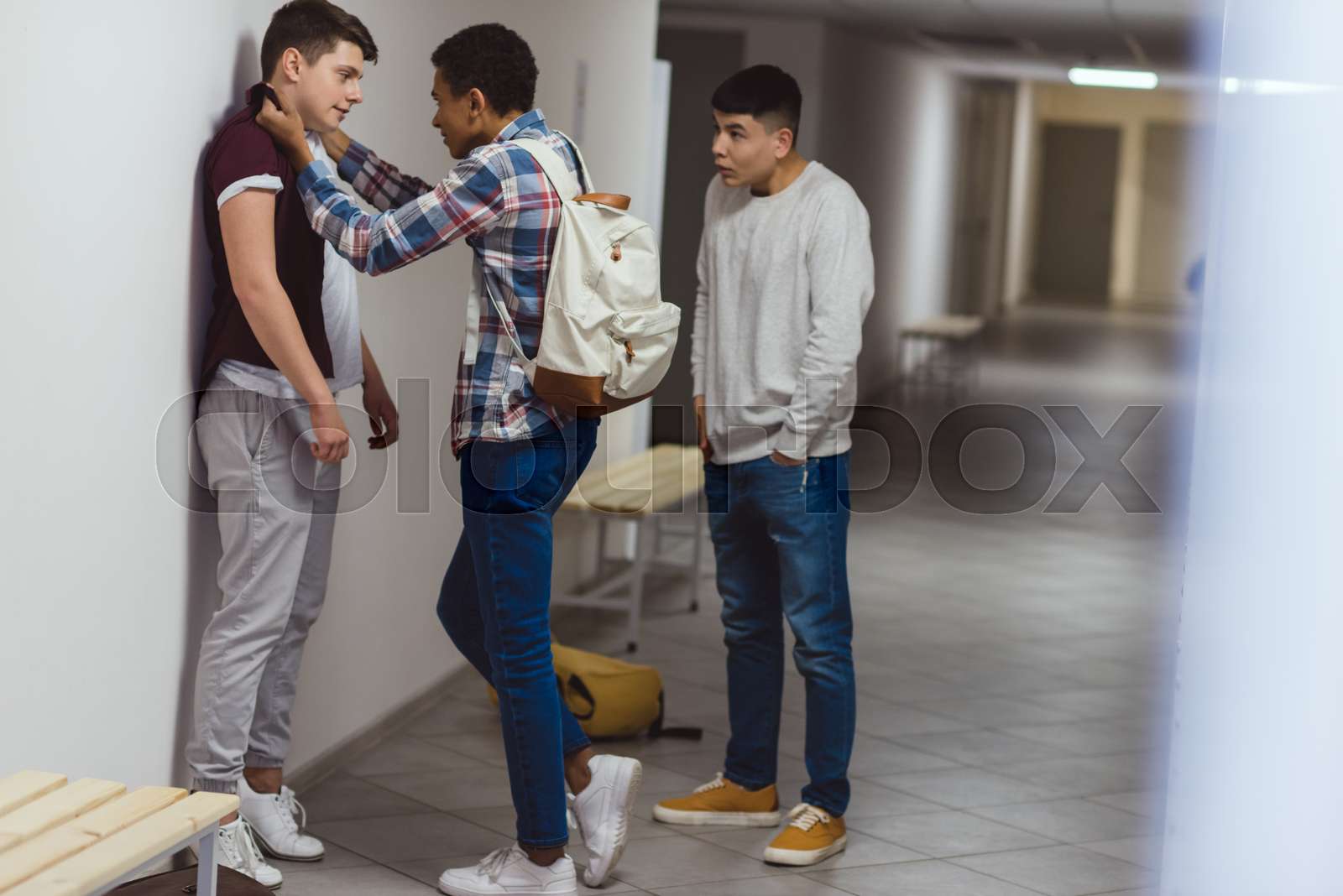 schoolboy being bullied by classmates in school corridor | Stock image ...