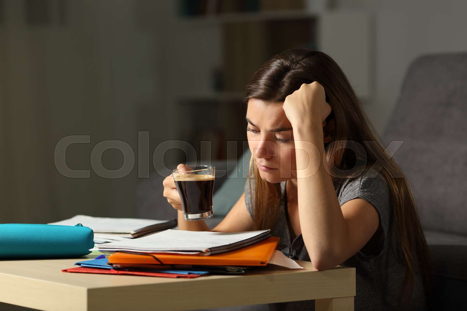 Tired student studying late hours drinking coffee | Stock image | Colourbox
