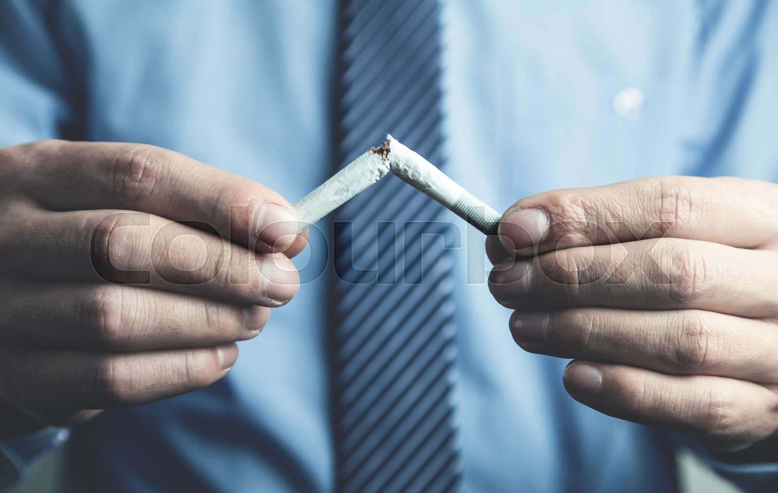 Man breaking a cigarette. Stop smoking | Stock image | Colourbox