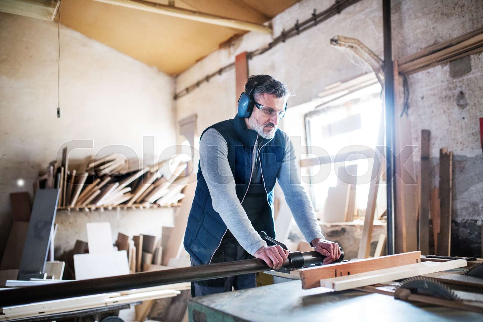 A man worker in the carpentry workshop, working with wood. | Stock ...