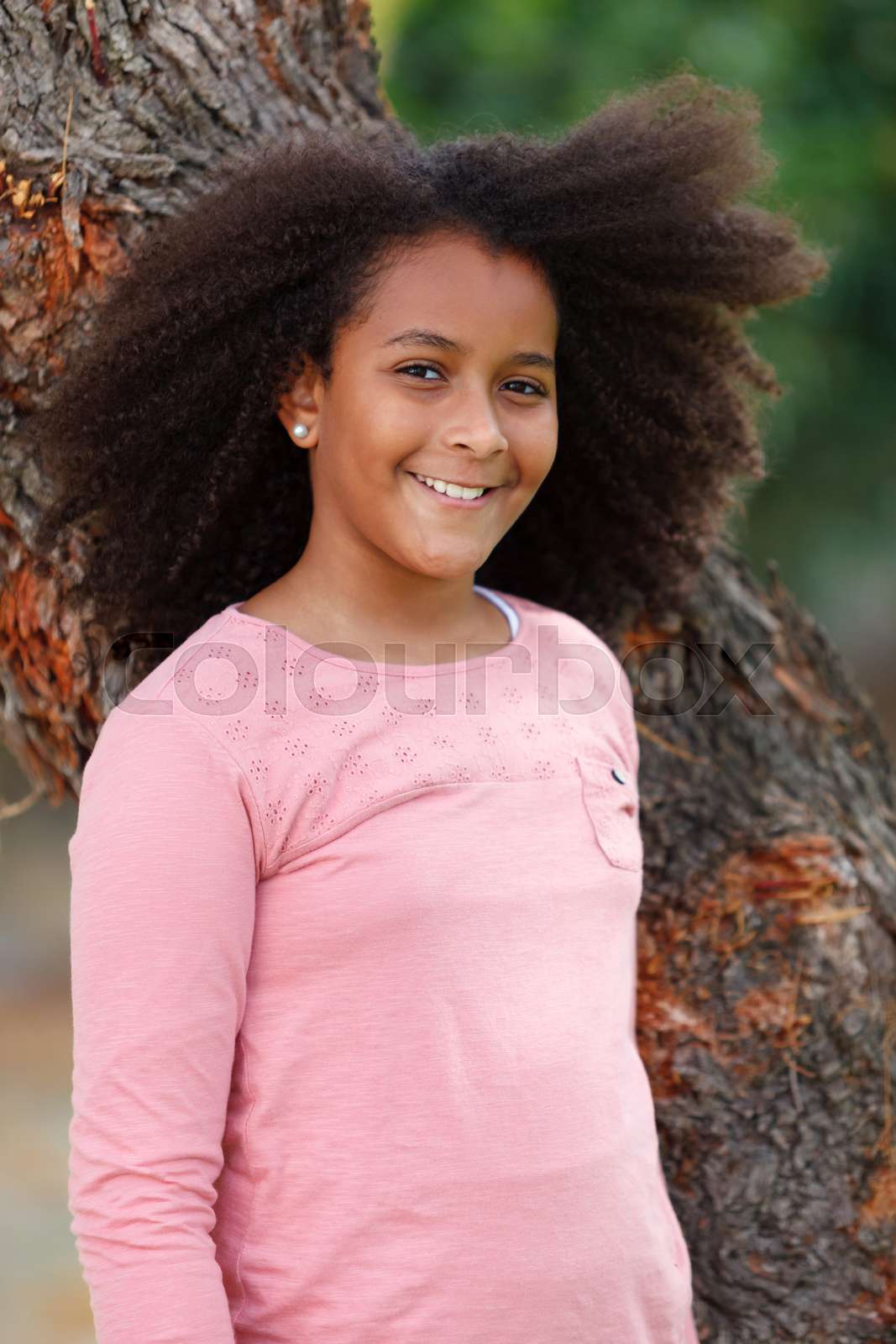Cute African American girl in the street with afro hair | Stock image ...
