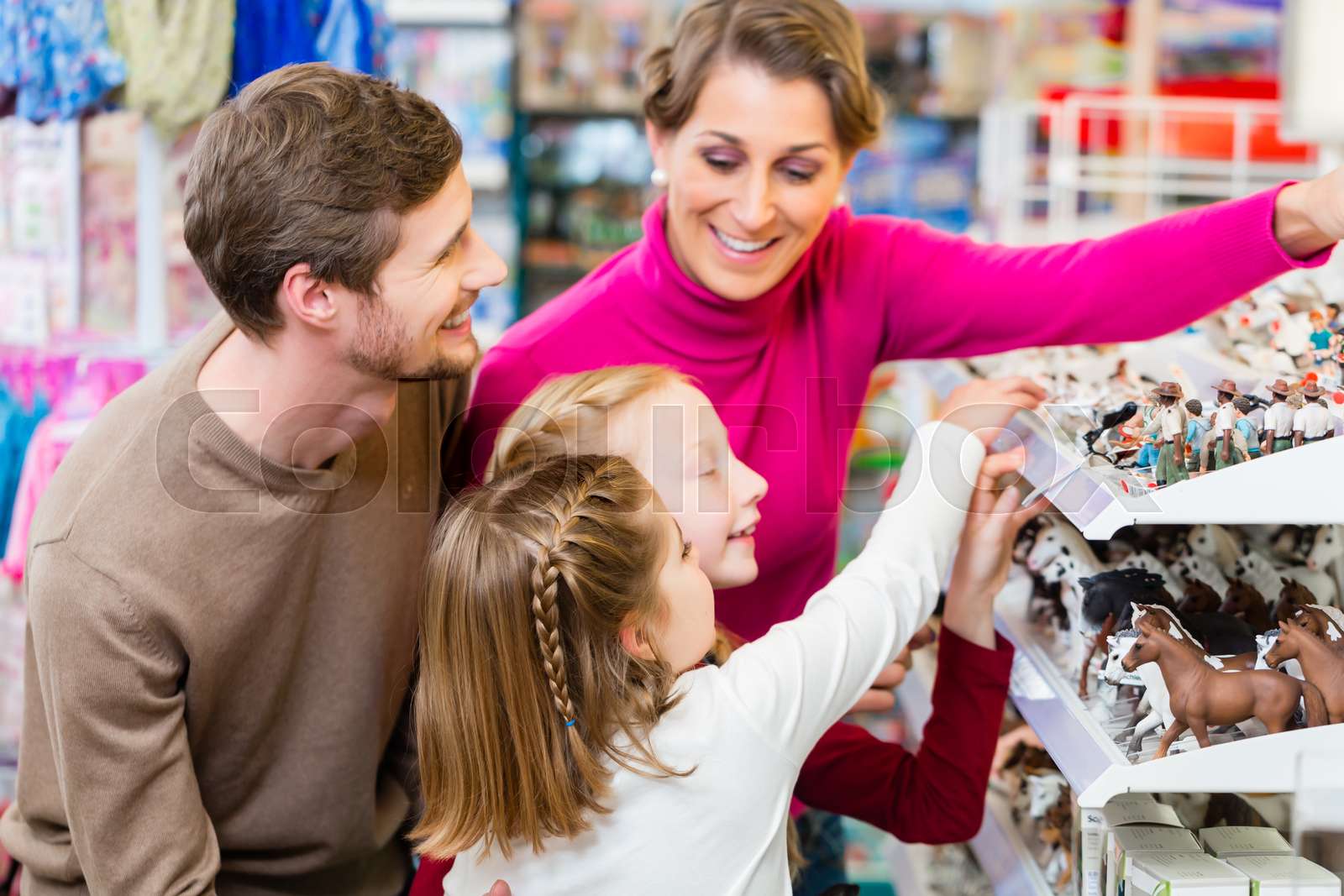 Family buying toys in toy store | Stock image | Colourbox