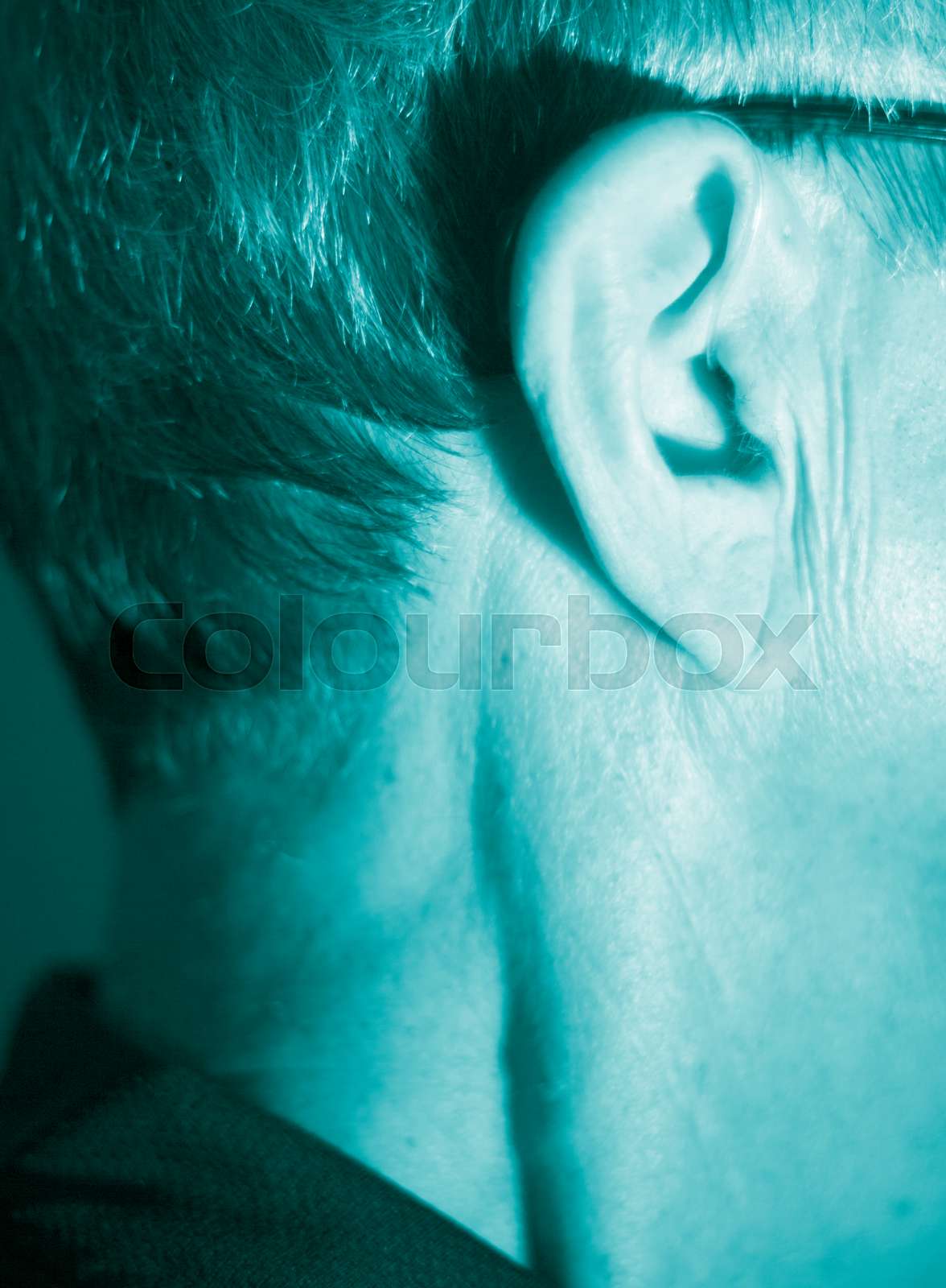 Deaf man hearing aid ear | Stock image | Colourbox