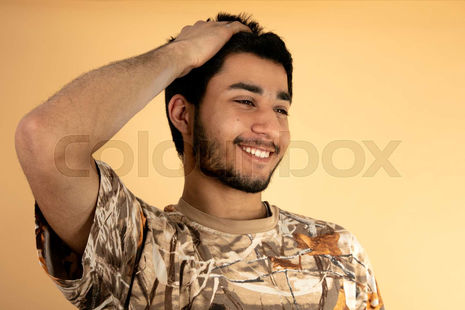 Young man with hand in his hair | Stock image | Colourbox