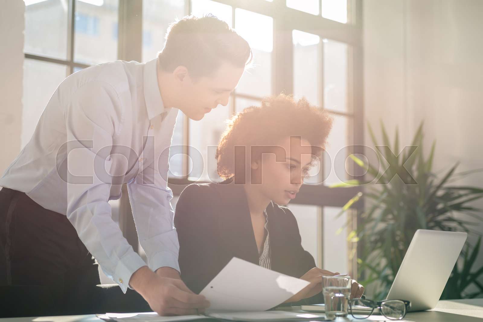 Skilled business man helping his colleague in the office | Stock image ...
