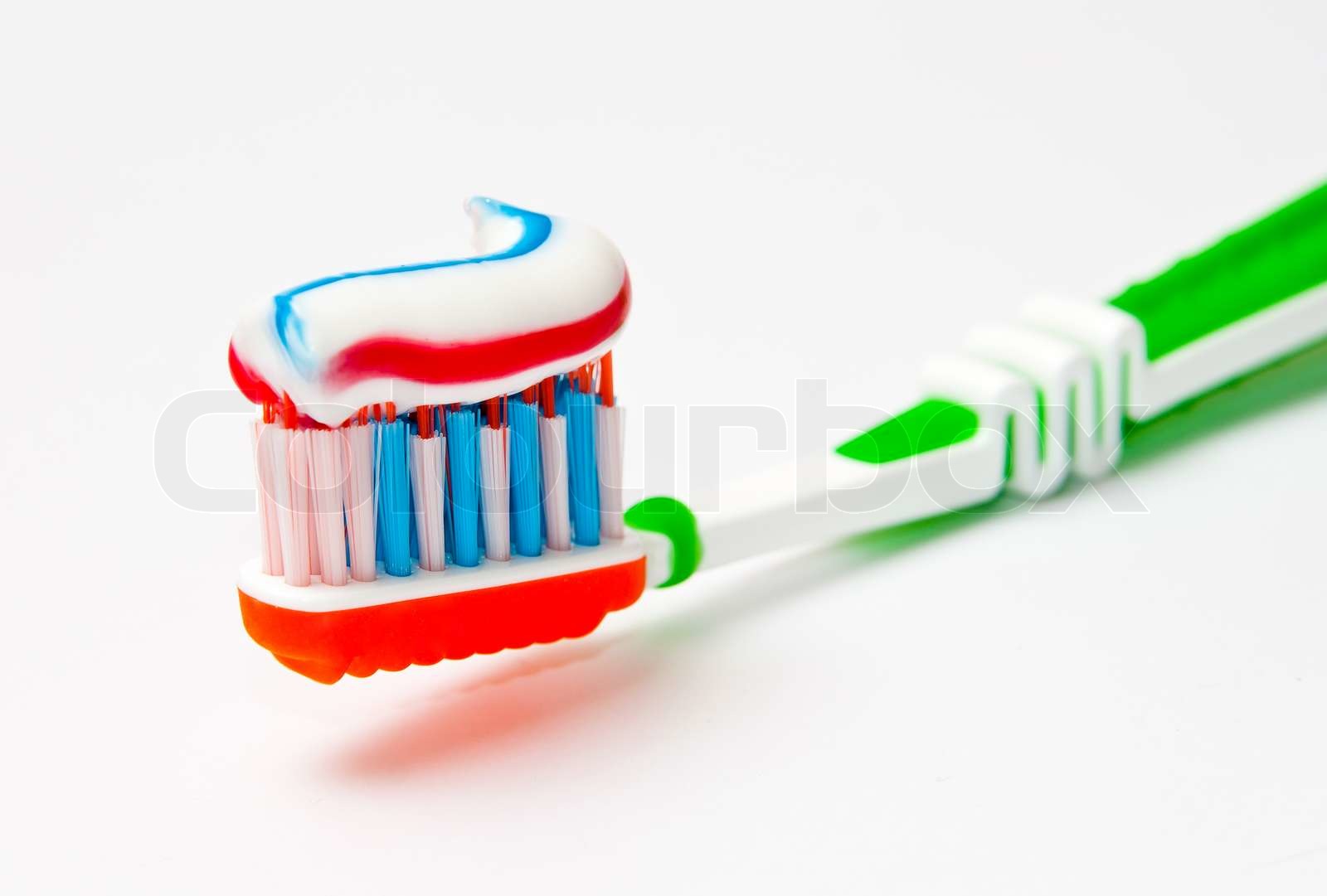 toothbrush with tricolor toothpaste | Stock image | Colourbox