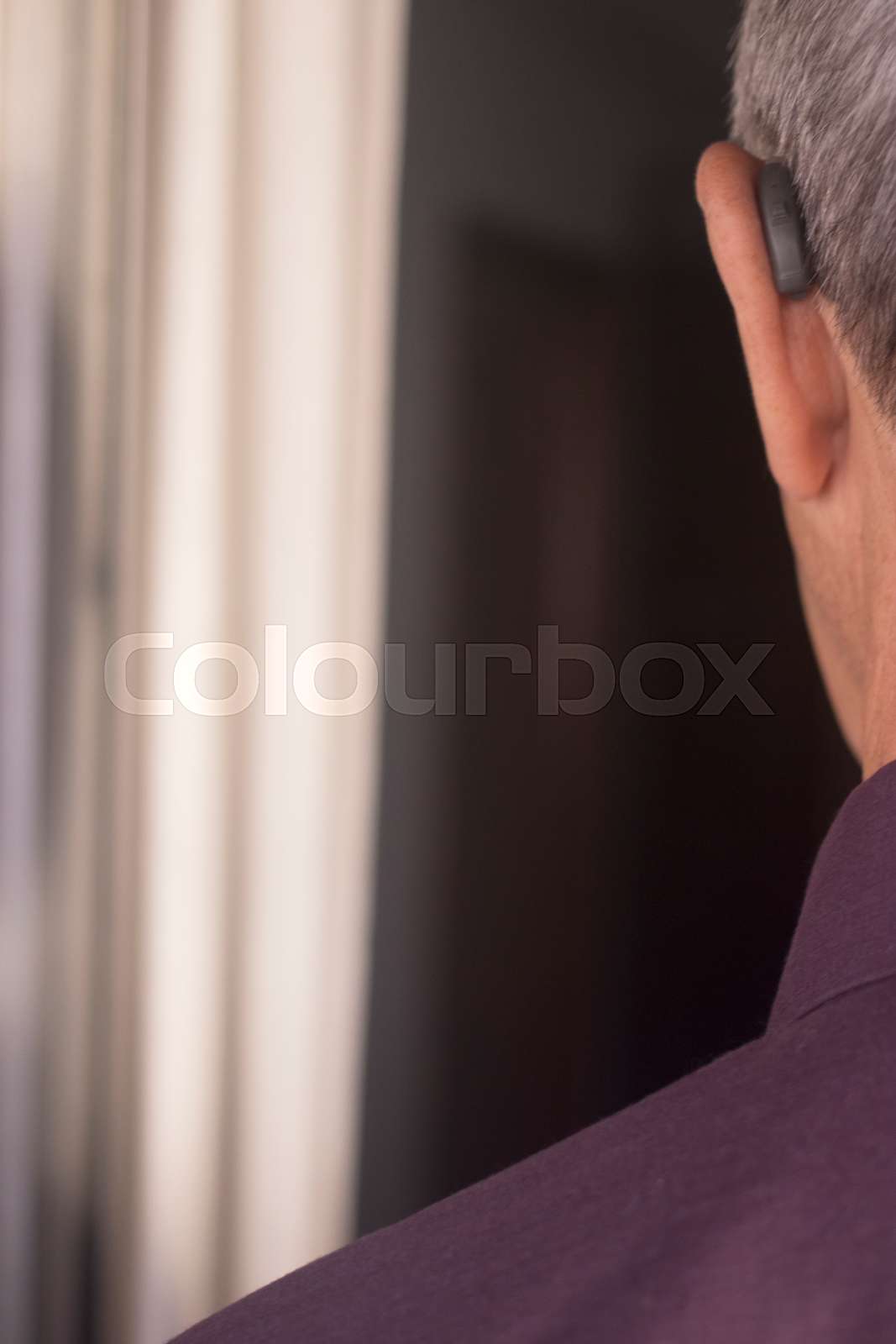 Deaf man hearing aid ear | Stock image | Colourbox