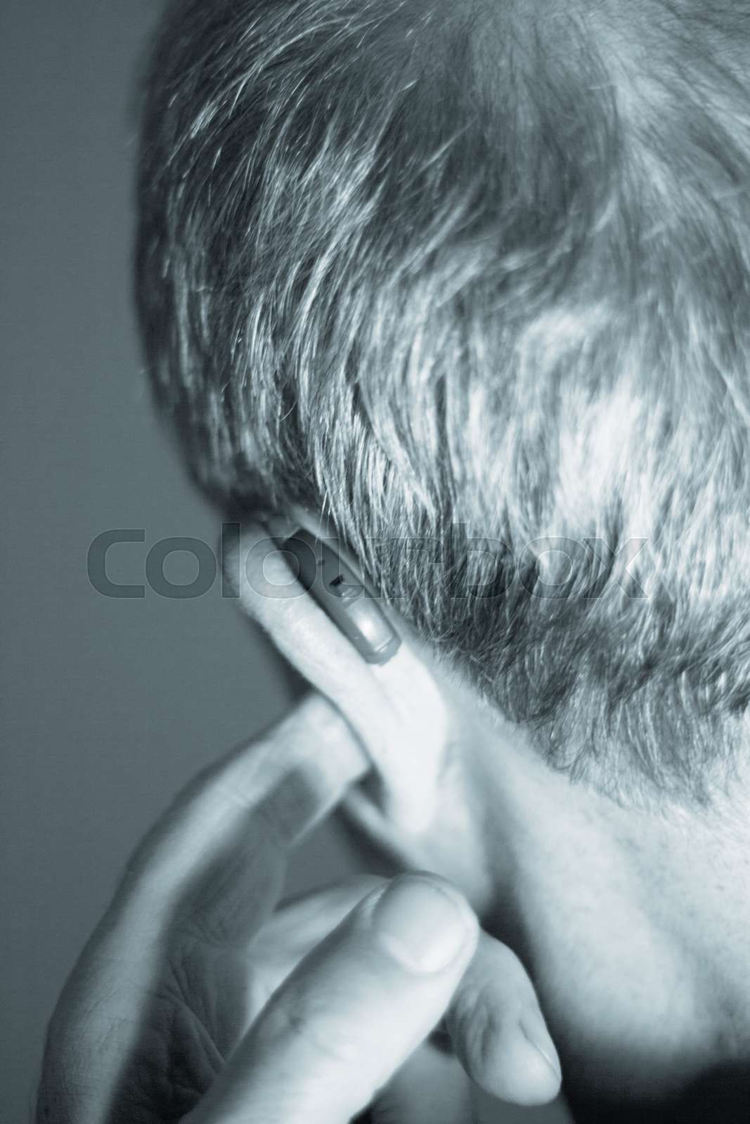 Deaf man hearing aid ear | Stock image | Colourbox