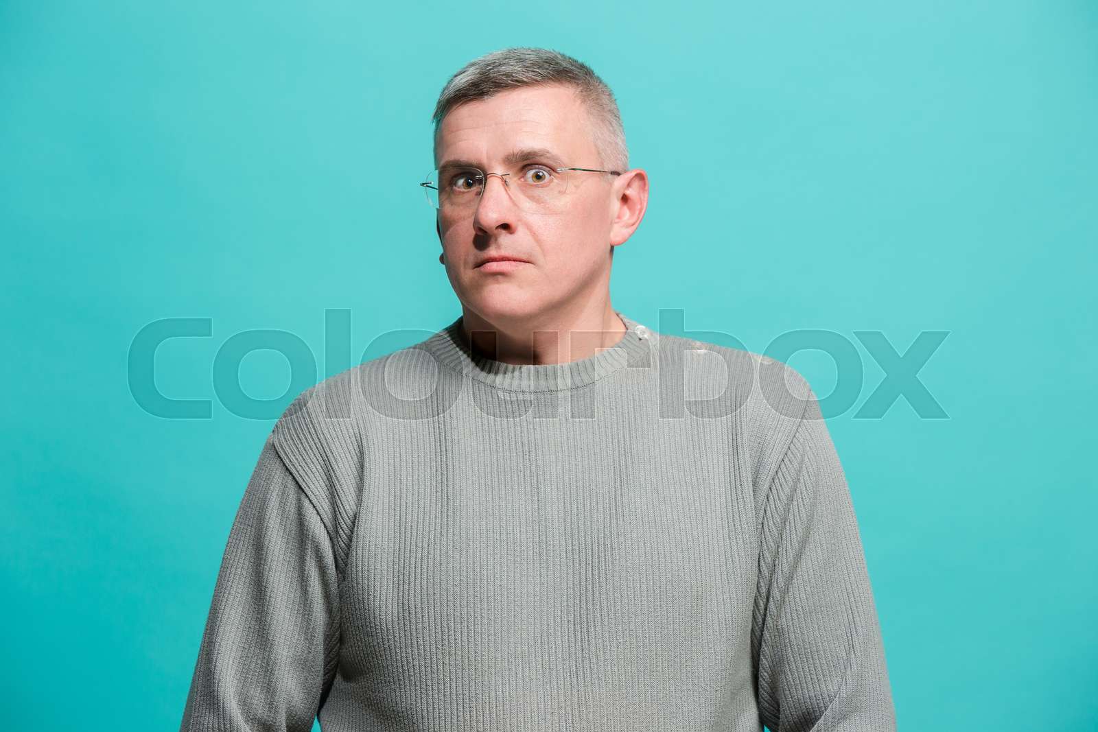 Portrait of the scared man on blue | Stock image | Colourbox