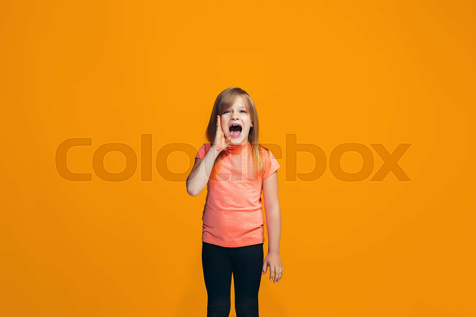 Isolated on pink young casual teen girl shouting at studio | Stock ...