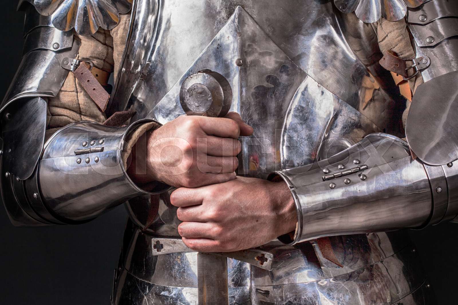 knight wearing armor and holding two-handed sword | Stock image | Colourbox