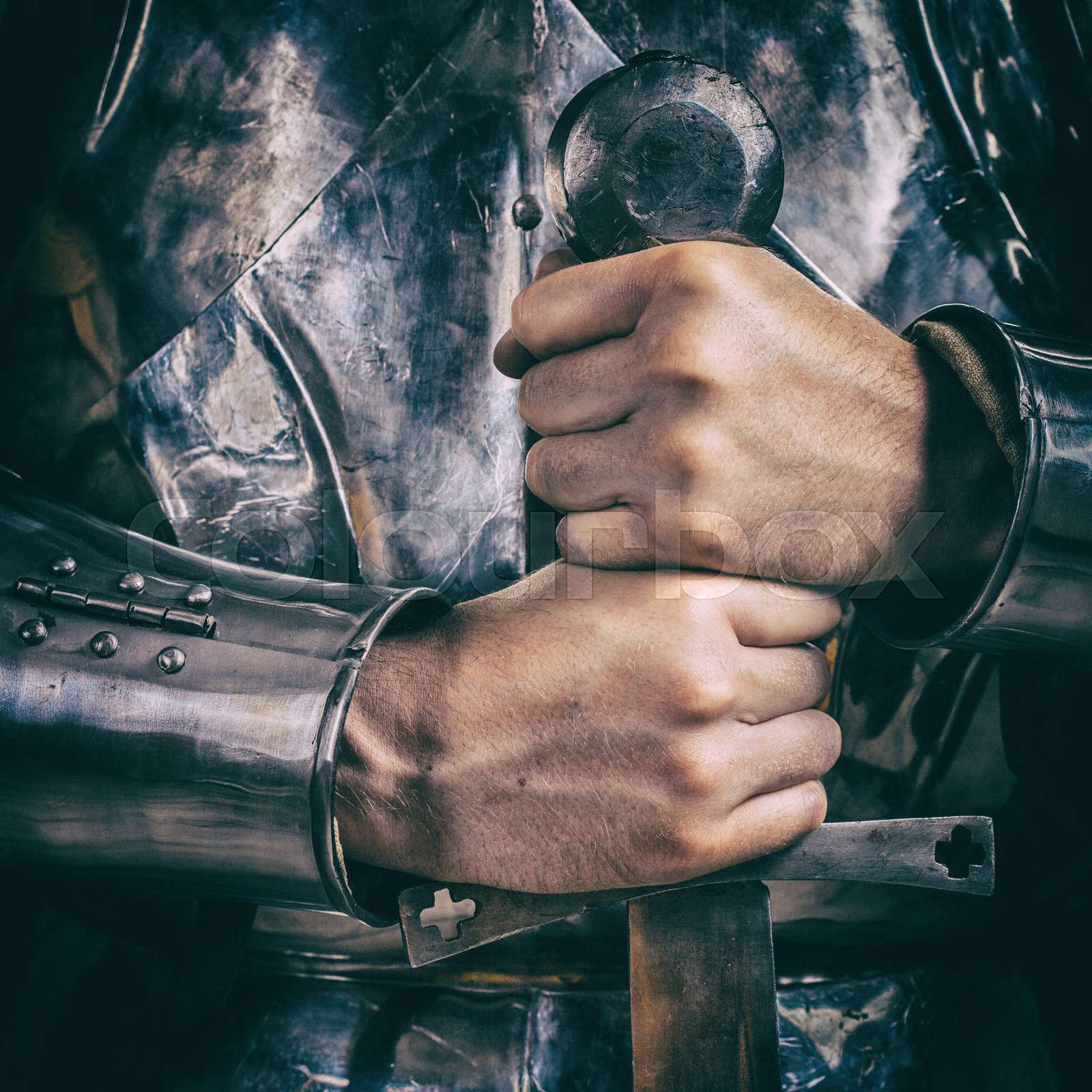 knight wearing armor and holding two-handed sword | Stock image | Colourbox