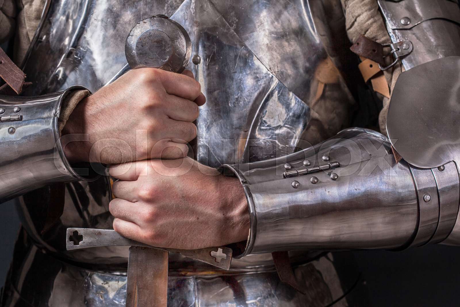 knight wearing armor and holding two-handed sword | Stock image | Colourbox