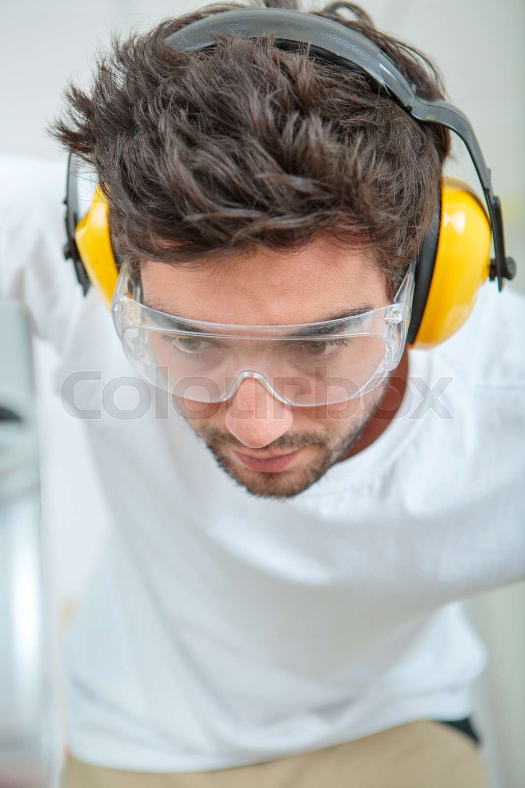 man wearing goggles and earmuffs | Stock image | Colourbox