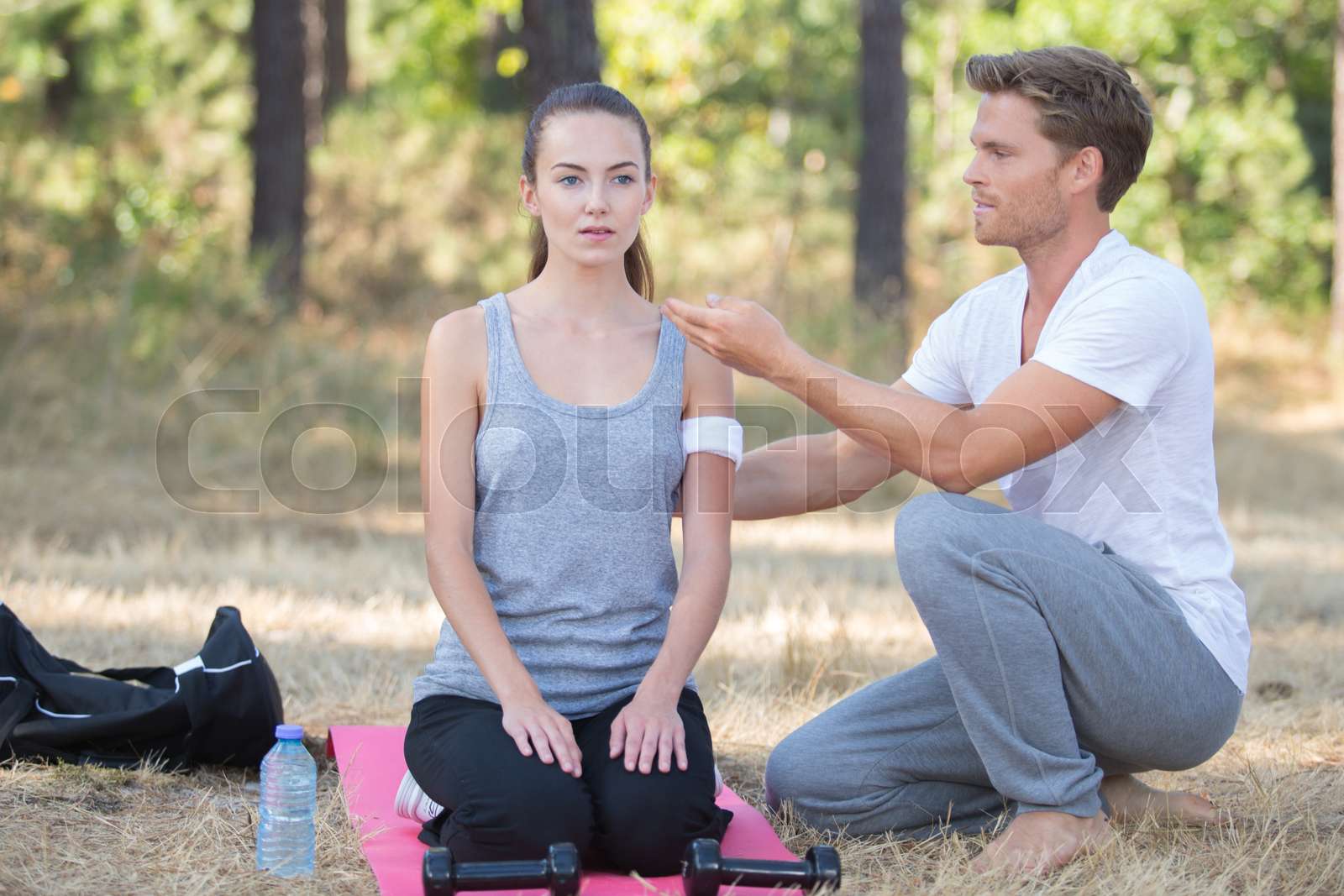personal trainer checking the position | Stock image | Colourbox