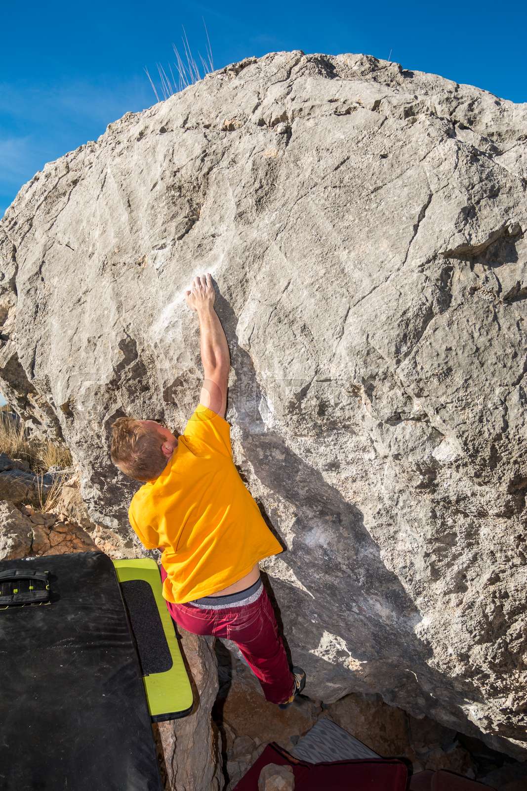 Back view of man climbing rock bouldering | Stock image | Colourbox