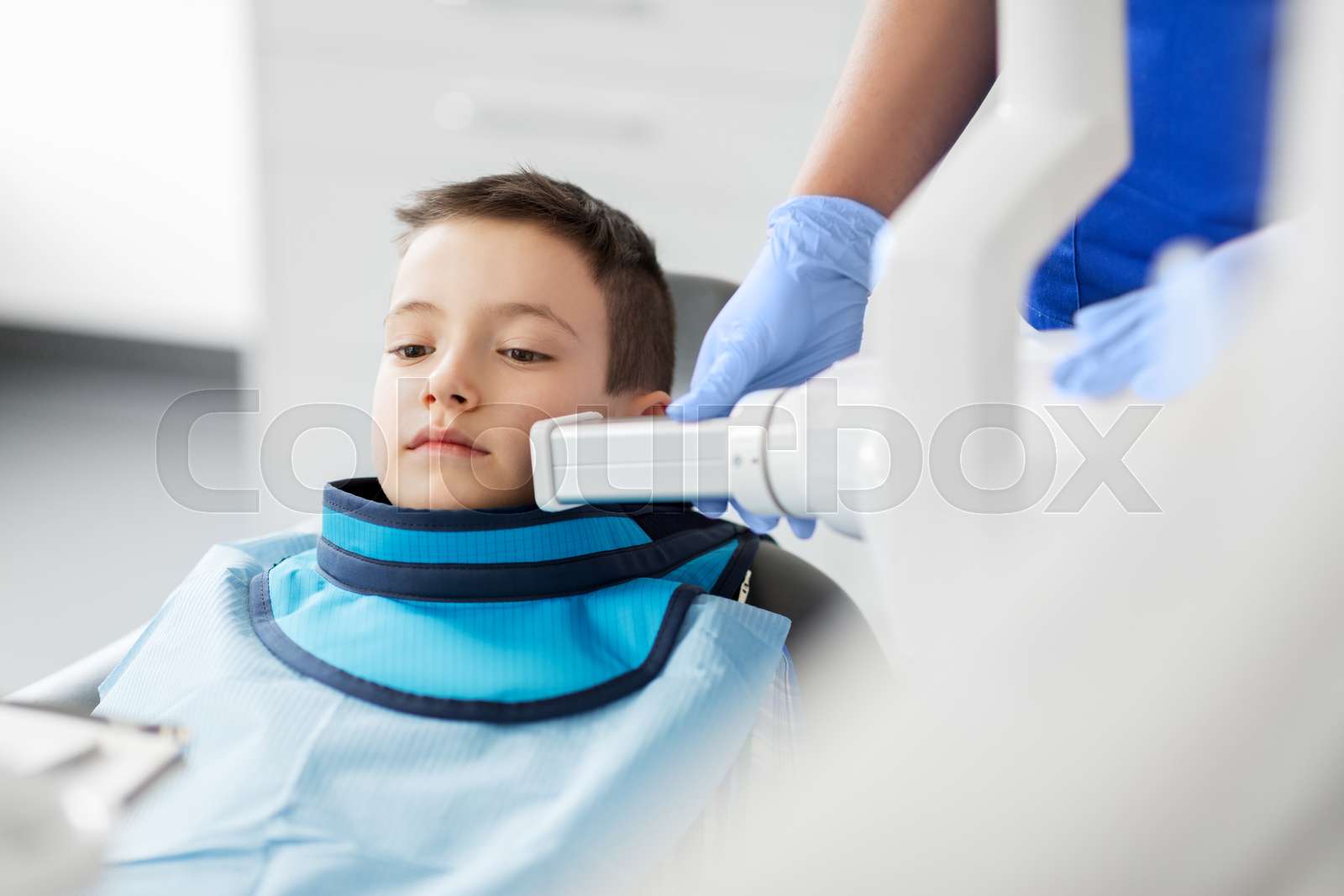 dentist making x-ray of kid teeth at dental clinic | Stock image ...