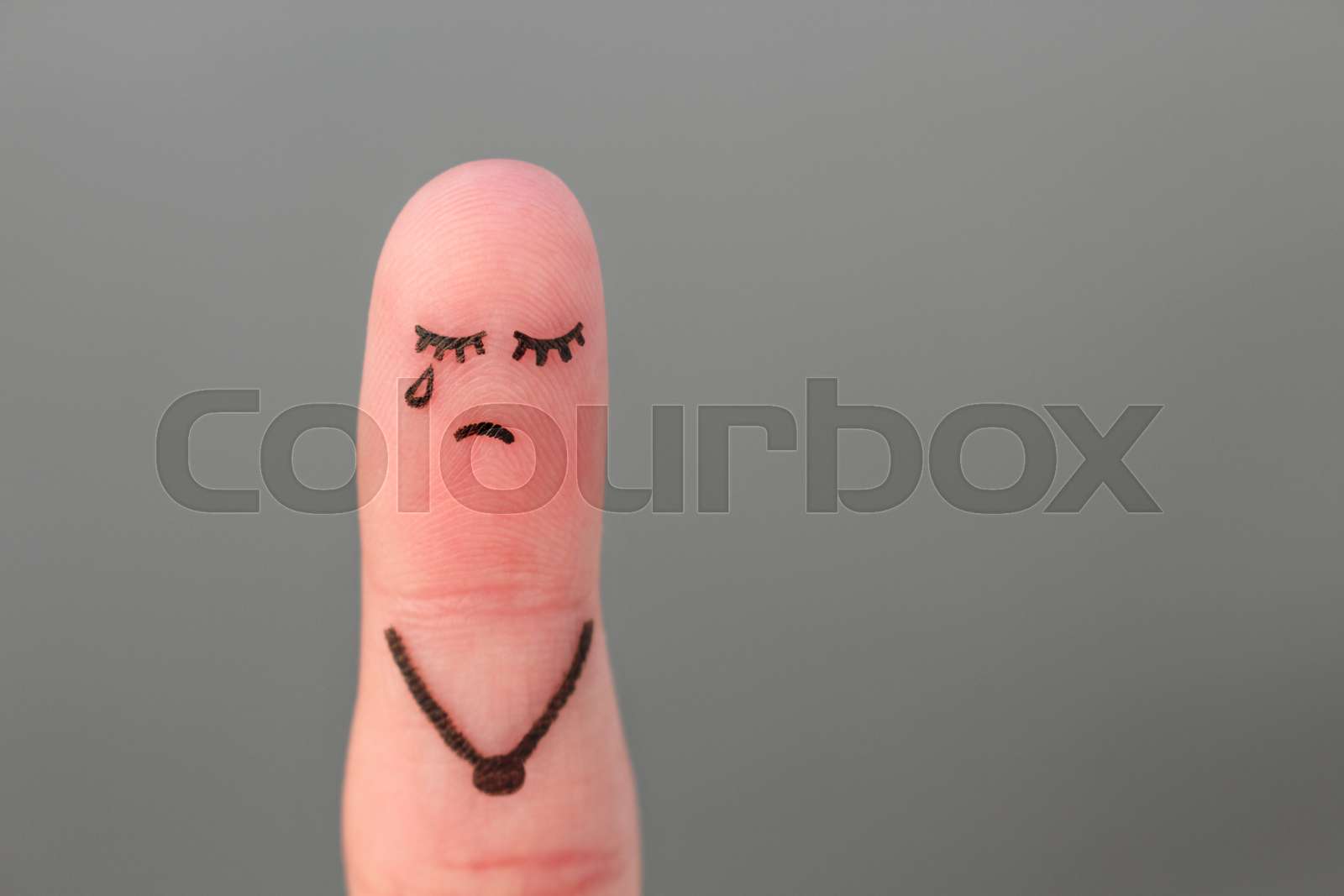 Finger art of lonely woman is crying. | Stock image | Colourbox
