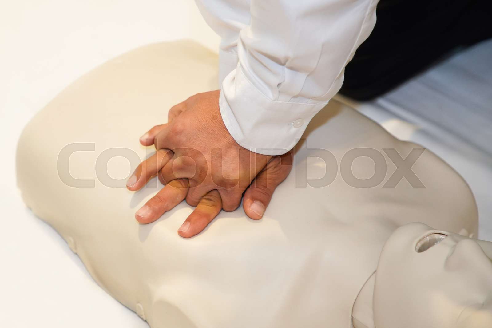 a man practicing CPR on a mannequin | Stock image | Colourbox