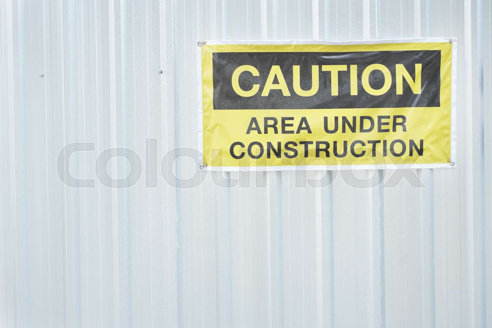 caution construction area sign on the metal wall | Stock image | Colourbox