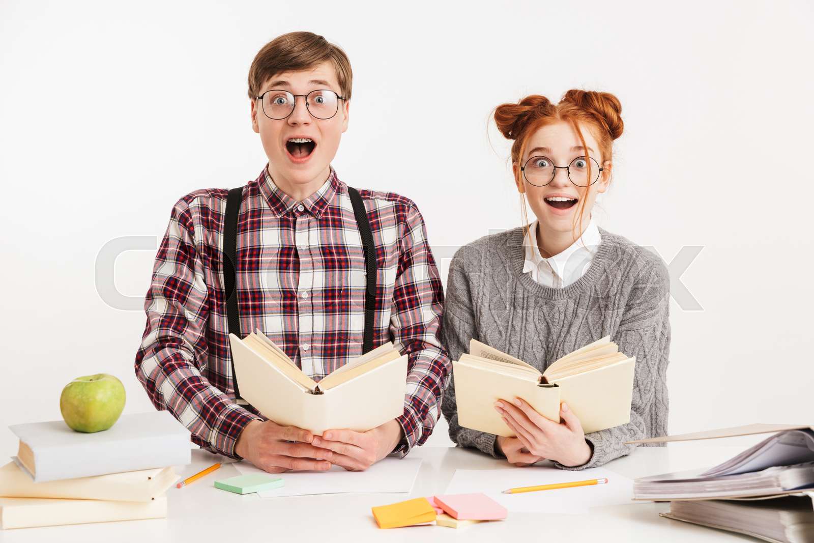Funny couple of school nerds reading books | Stock image | Colourbox