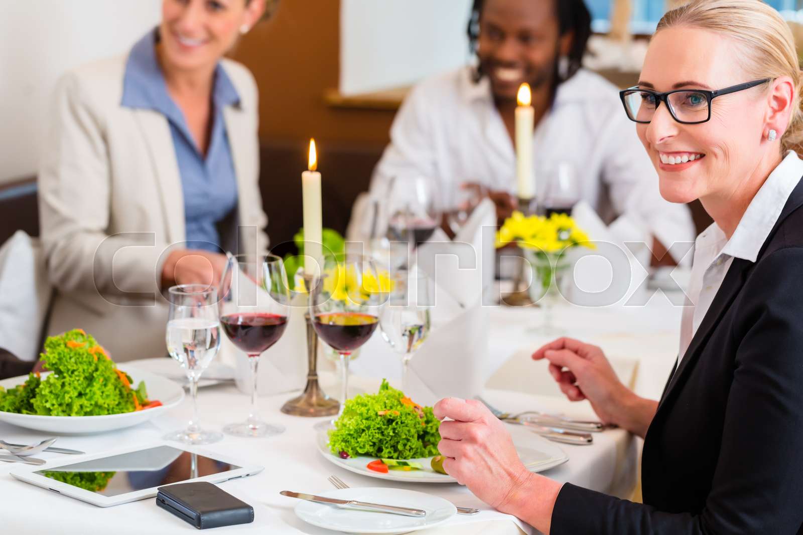 People in restaurant at business lunch talking | Stock image | Colourbox
