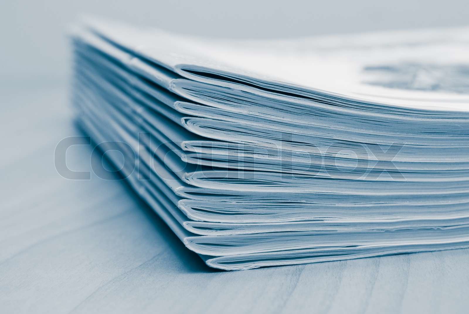 Stack of white journals on table, closeup blue toned | Stock image ...