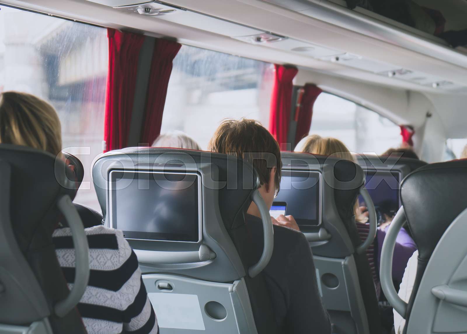 Tourist bus with passengers and built-in LCD tablets. | Stock image ...