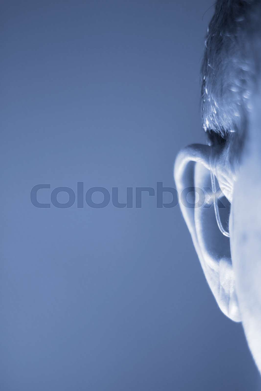 Deaf man hearing aid ear | Stock image | Colourbox