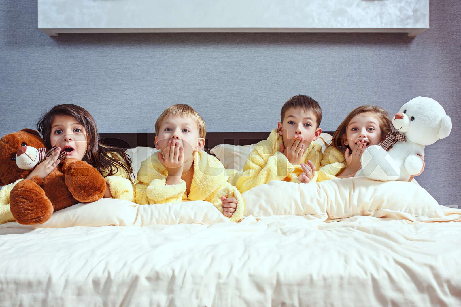 The group of friends taking goog time on bed | Stock image | Colourbox