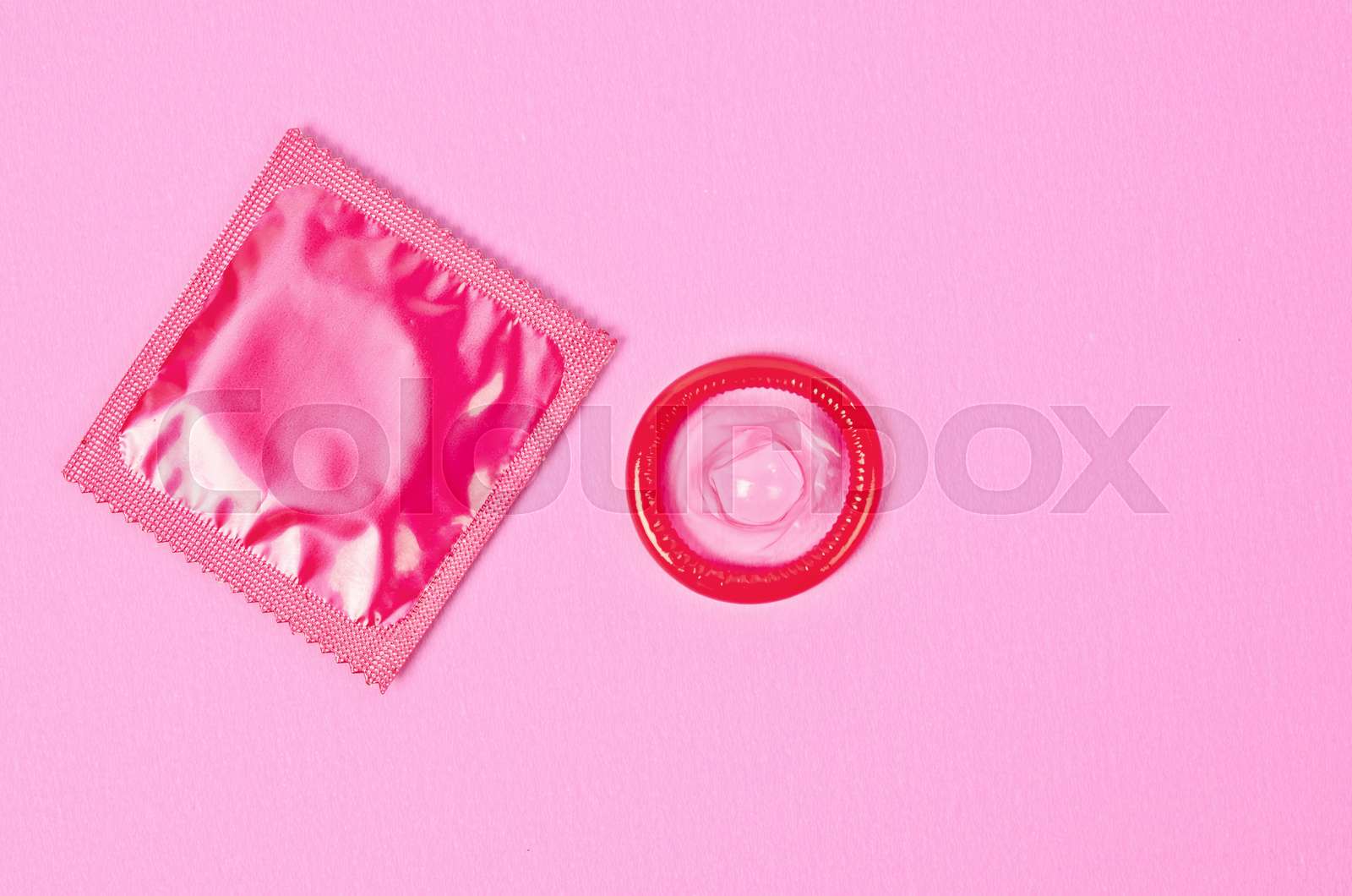 Pink opened condom. | Stock image | Colourbox
