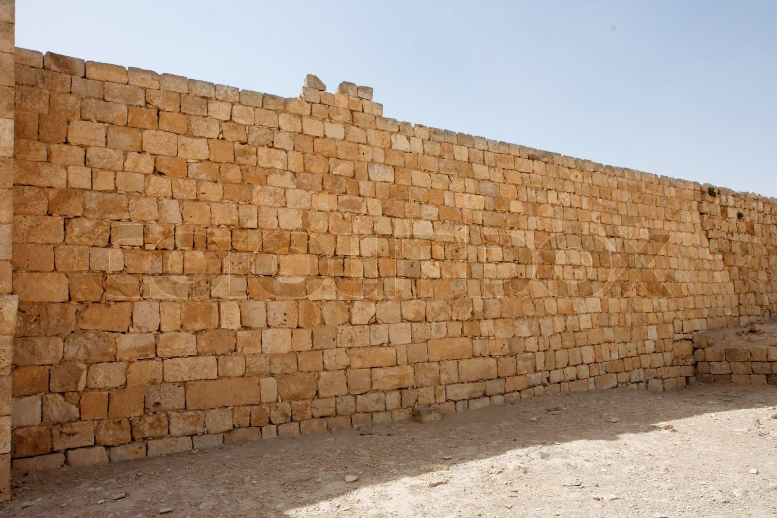 Ancient wall built of yellow stone blocks | Stock image | Colourbox