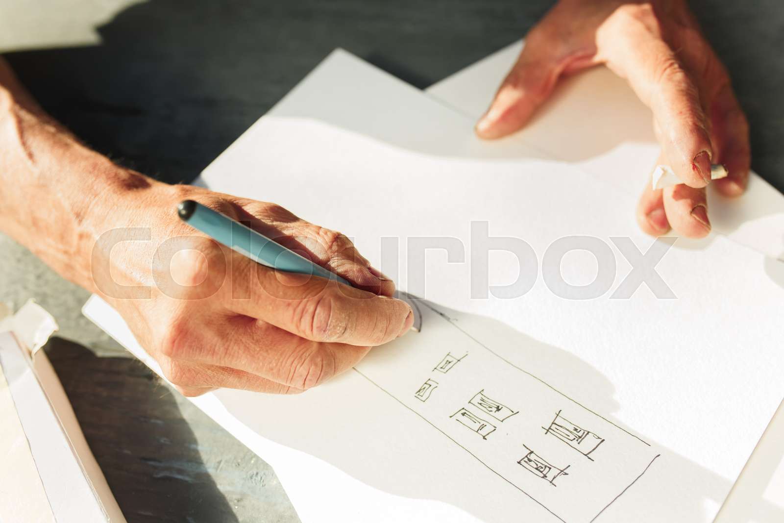 Close up man working of Architect sketching a construction project on ...