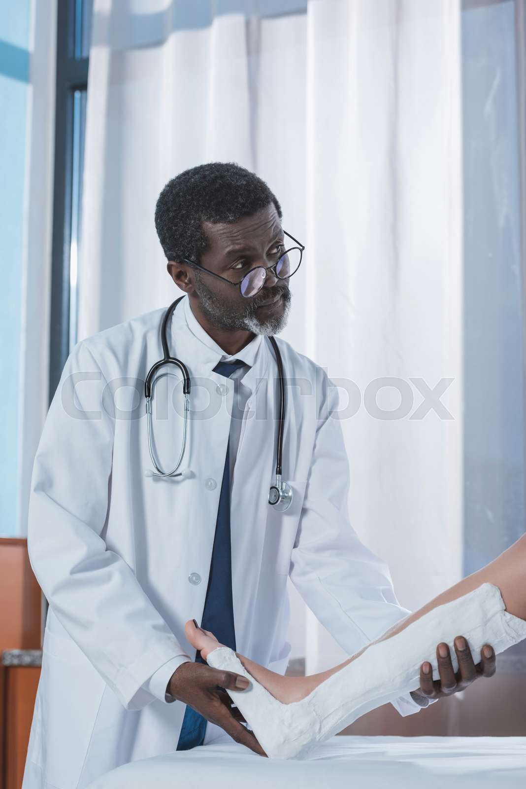 doctor putting on plaster cast | Stock image | Colourbox