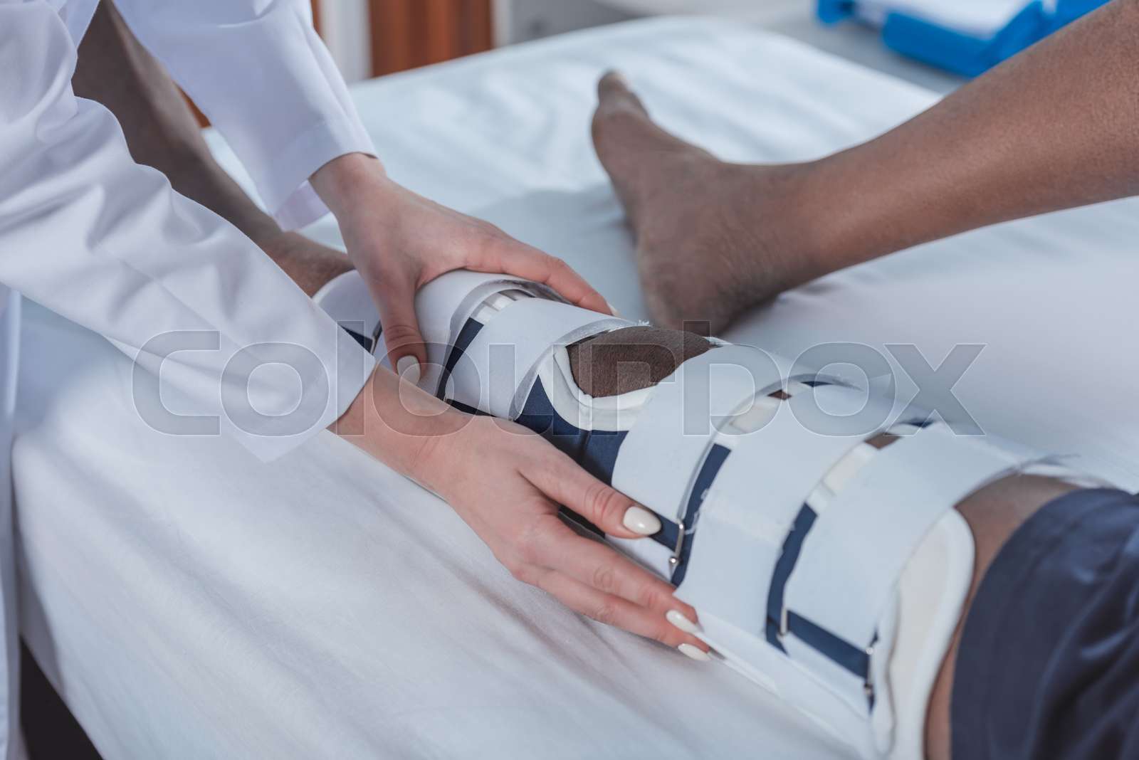 doctor checking patient leg brace | Stock image | Colourbox