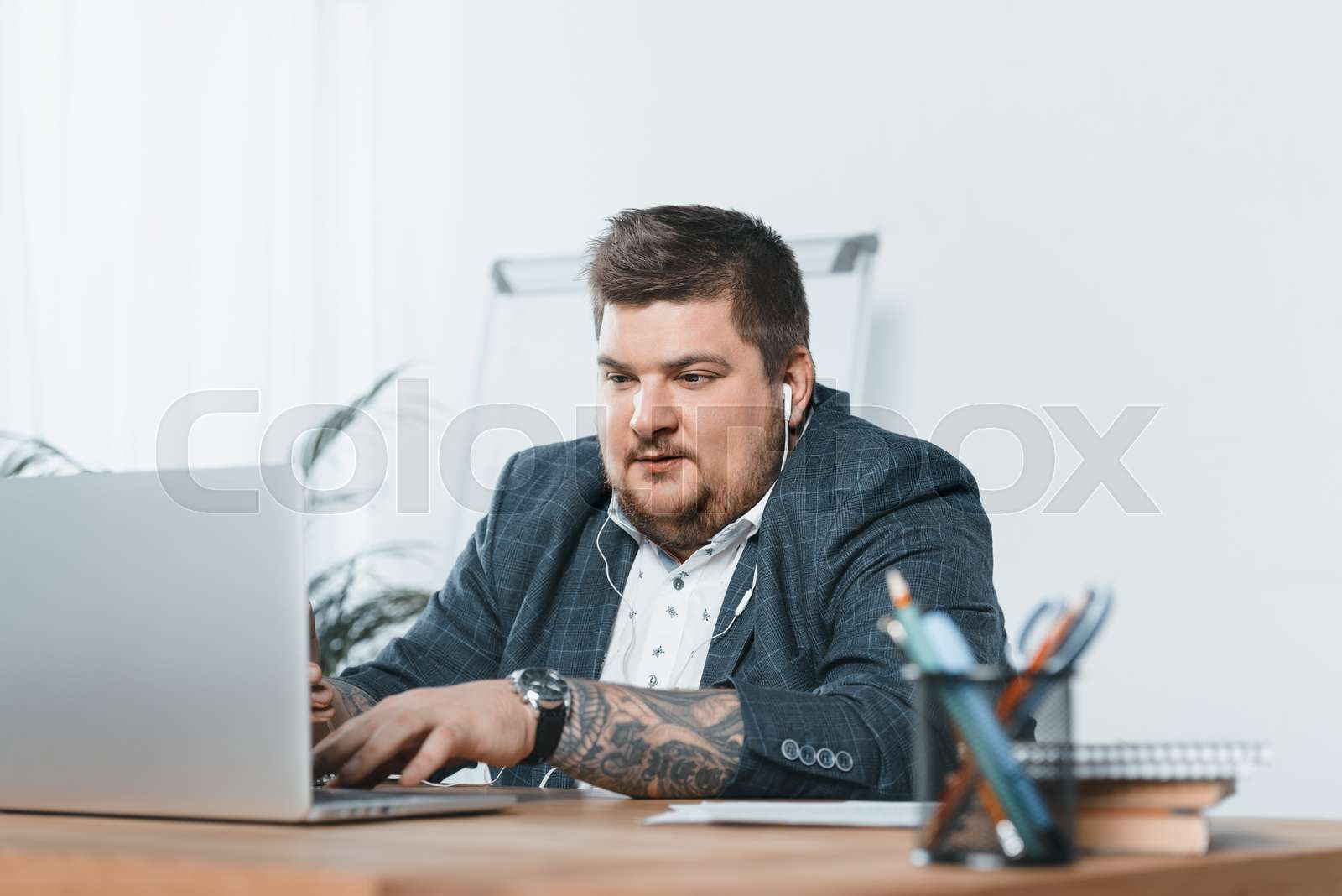 overweight businessman at workplace | Stock image | Colourbox