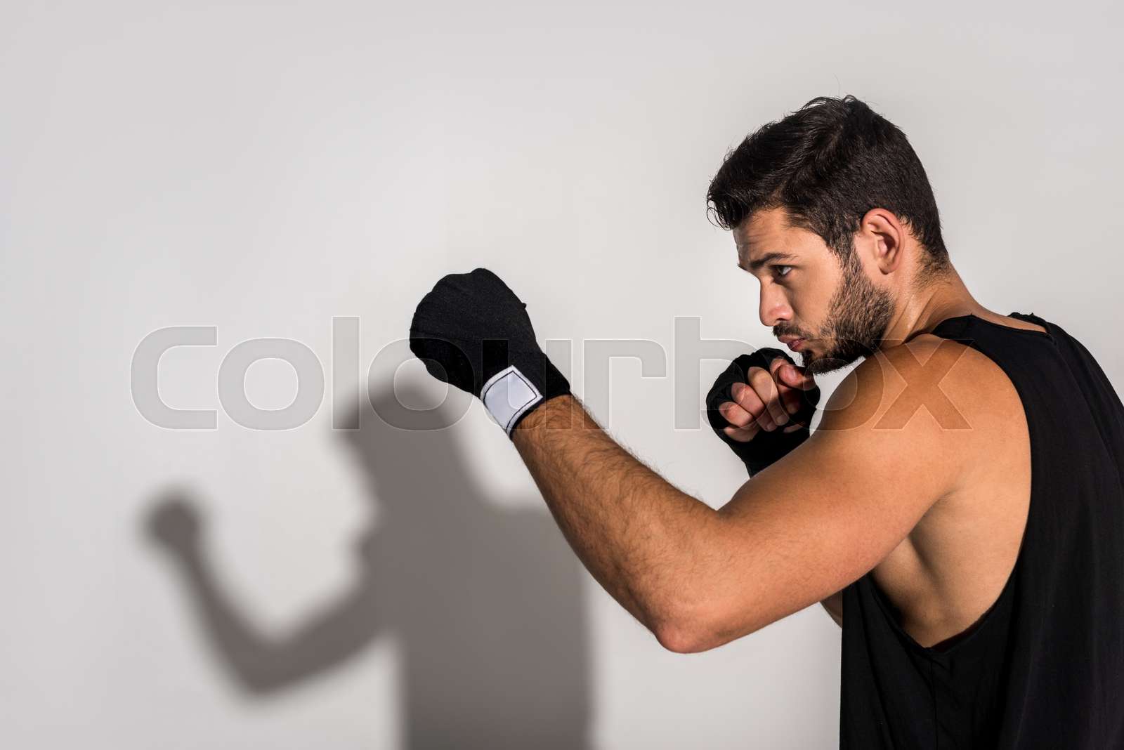 side view of young fighter standing in defence position | Stock image ...