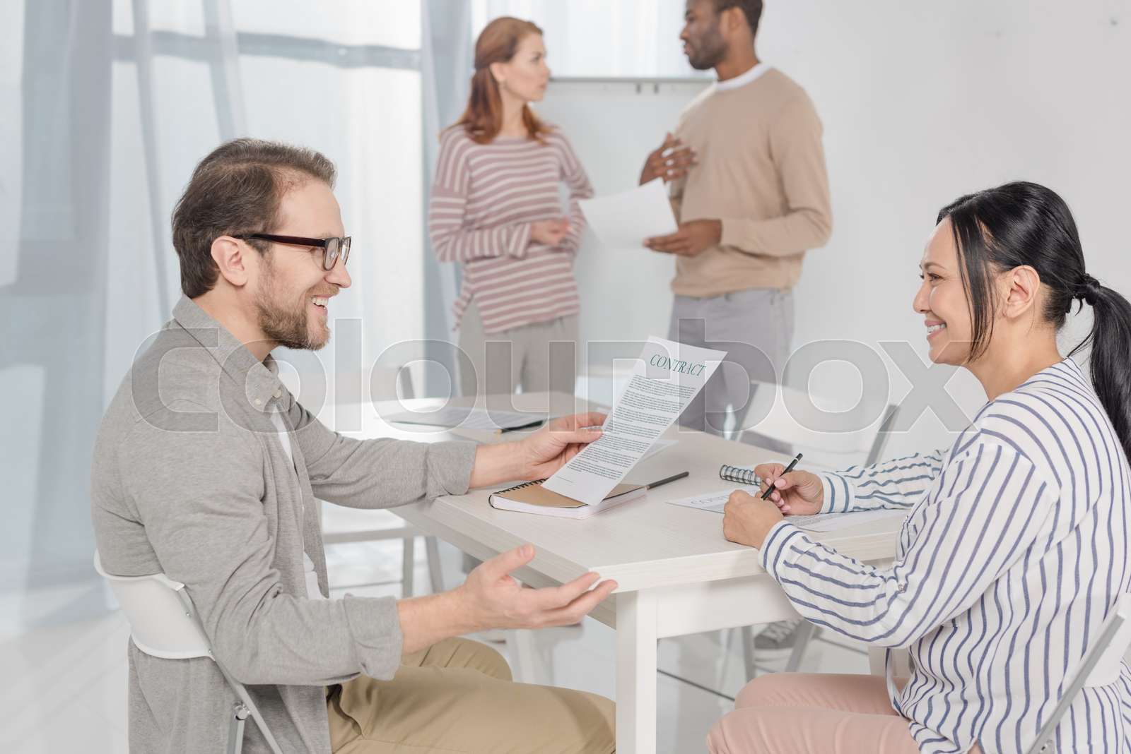 middle aged people talking while working | Stock image | Colourbox