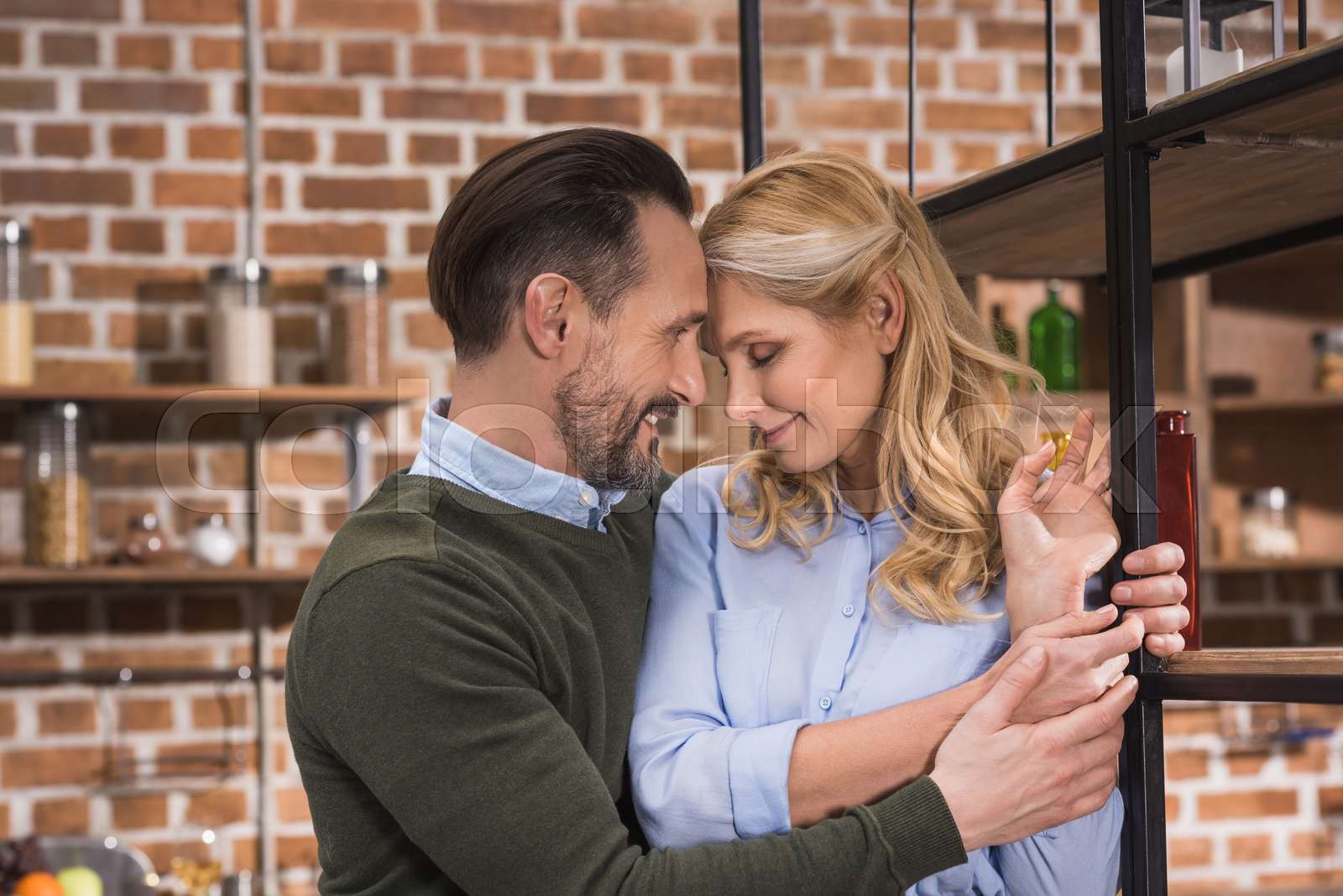 happy husband hugging wife at kitchen | Stock image | Colourbox