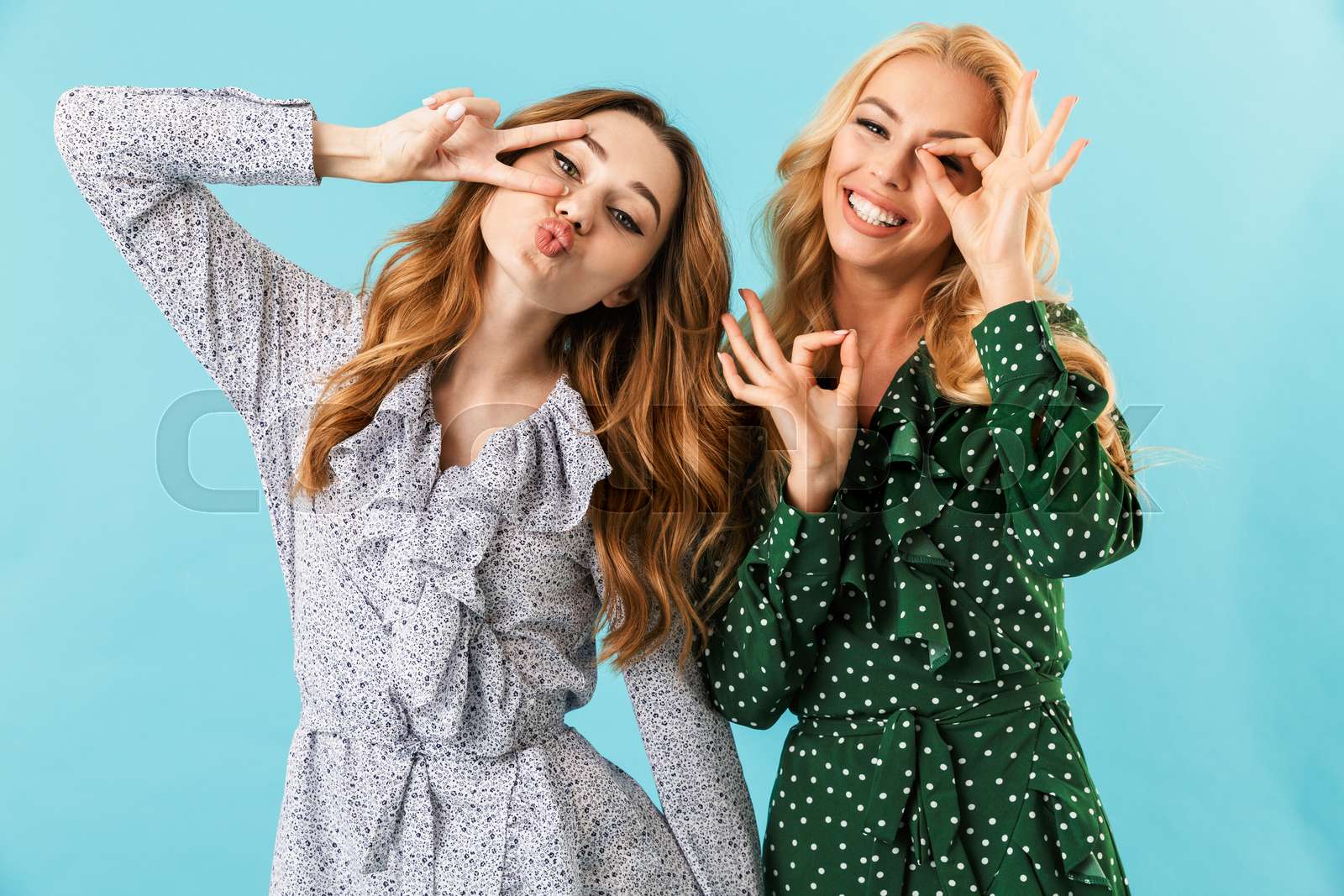 Two women in dresses having fun and looking at camera | Stock image ...