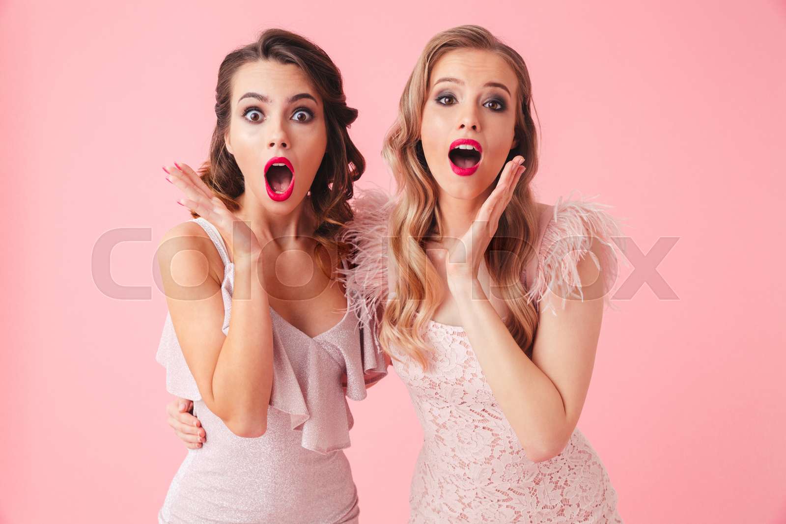 Two shocked women in dresses hugging to each other | Stock image ...